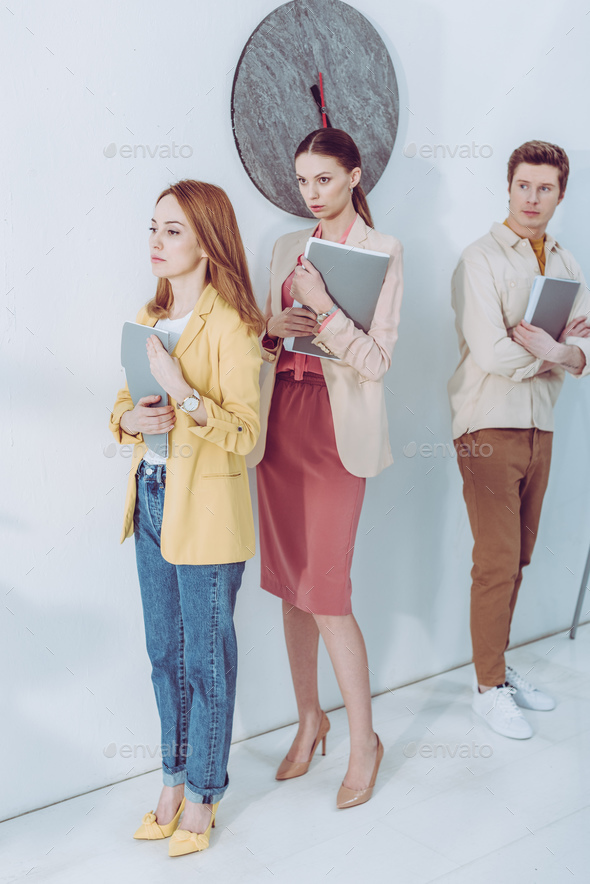worried women and handsome man waiting in line with folders Stock Photo ...