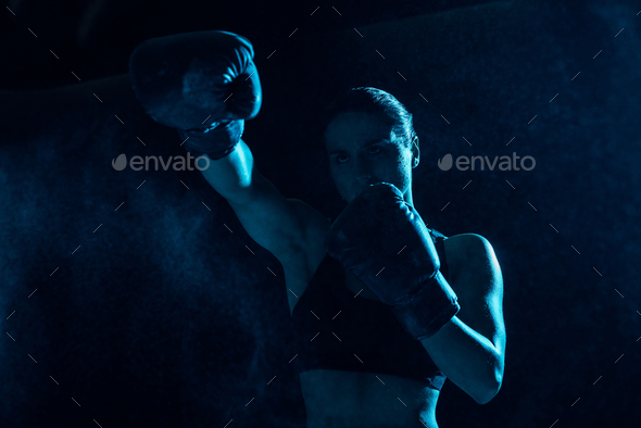 Serious boxer in boxing gloves training and looking away Stock Photo by ...