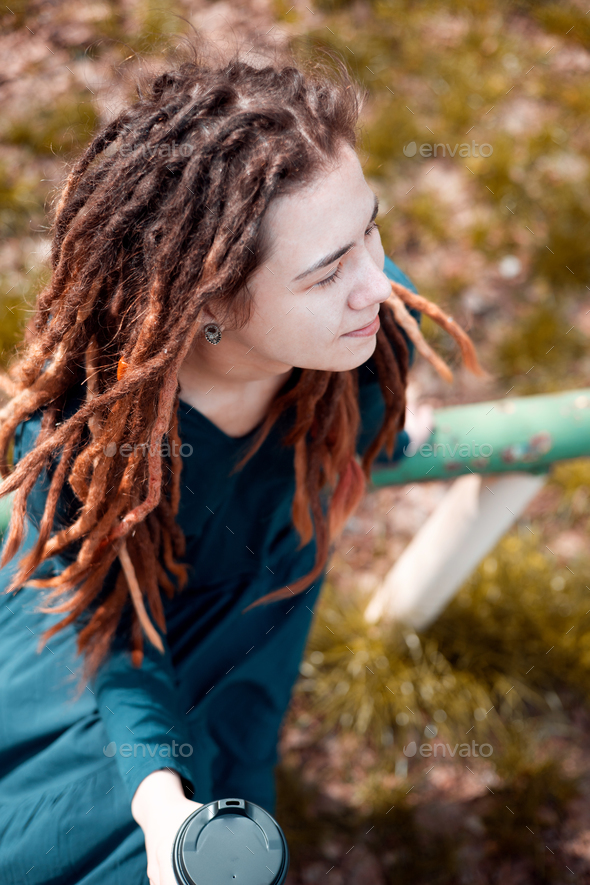 Millennial cool pretty girl with dreadlocks hairstyle smoking cigarette ...