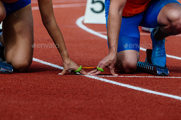 female blind para athlete runner with male guide in starting blocks ...