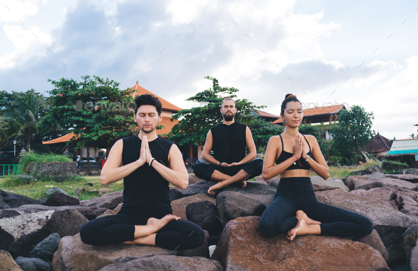 Tranquil male and female concentrated on namaste asana enjoying harmony ...