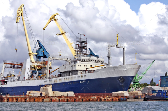 Cargo vessel standing at the trading seaport Stock Photo by Cebas ...