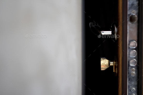 half opened door to a living room. Door handle, door lock. Opening door ...