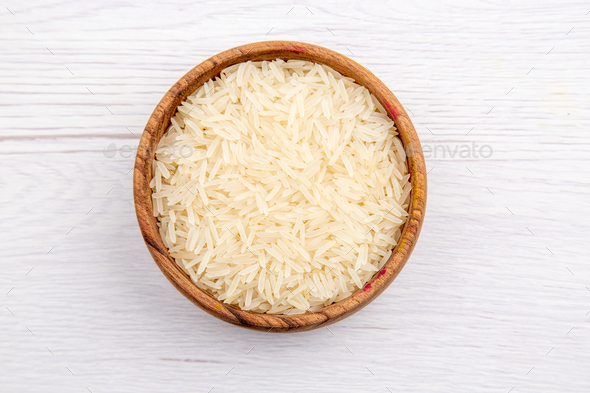 Overhead view of long rice in a brown bowl on white background Stock ...
