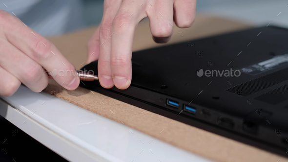 Unrecognizable engineer separating computer from case. Electronic ...
