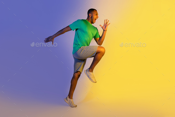 Black Guy Shouting Running Over Blue And Yellow Neon Background Stock ...
