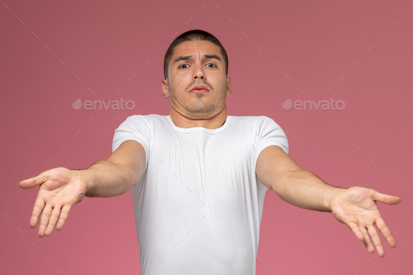 front view young male in white shirt posing with confused expression on ...