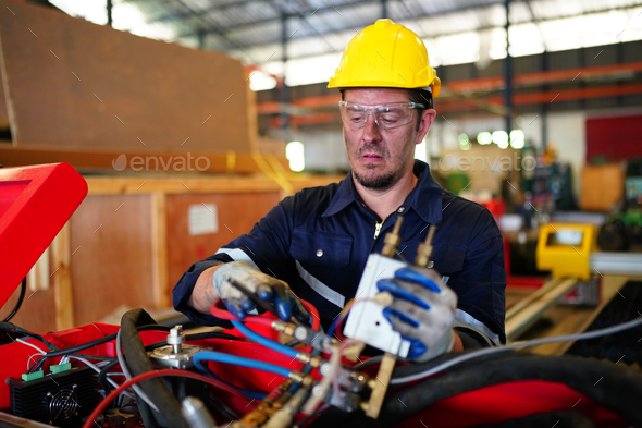 Robotic Arm engineer check on equipment in its with software of ...