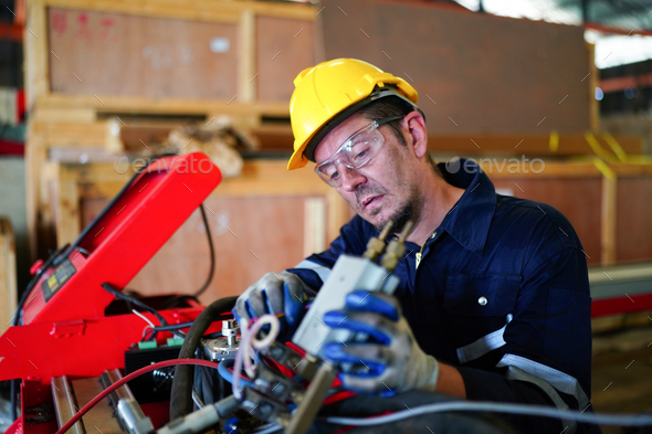 Robotic Arm engineer check on equipment in its with software of ...