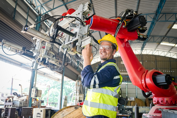 Robotic Arm engineer check on equipment in its with software of ...