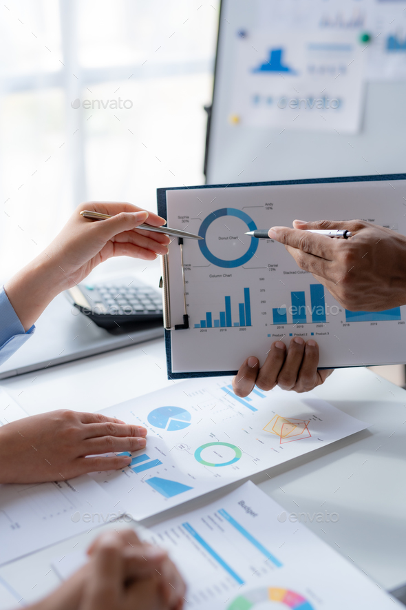 Business team together making investment plan at meeting pointing at ...