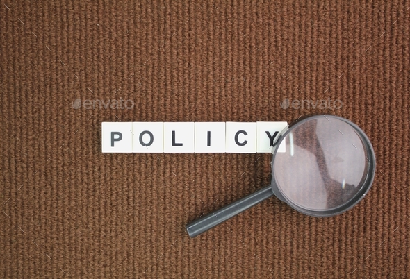 magnifying glass and alphabet letters with word policy. Stock Photo by ...