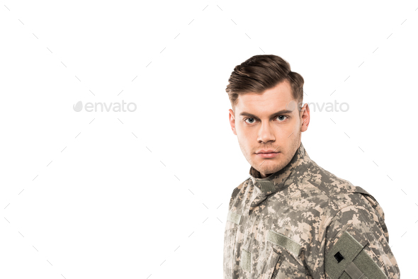 serious and handsome soldier in uniform looking at camera isolated on ...
