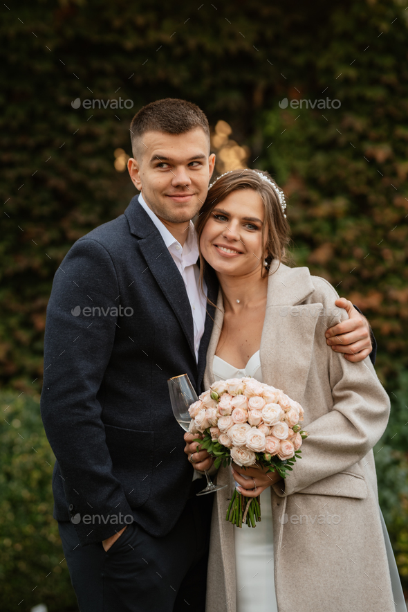 portrait of a young couple of bride and groom on their wedding day ...
