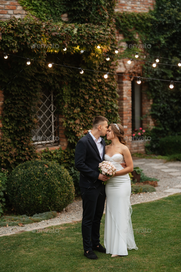 portrait of a young couple of bride and groom on their wedding day ...