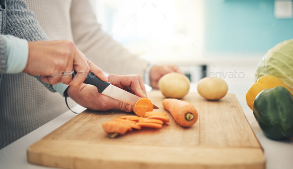 Cutting board, person or hands cook vegetables in a kitchen for healthy ...