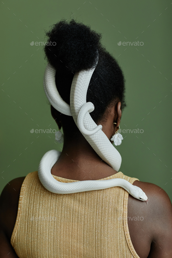 Back view of young African American woman with white snake Stock Photo ...