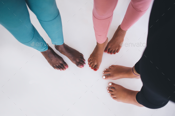 Female friends with pedicure have photo session as barefoot models in ...