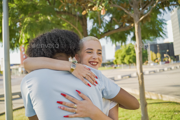 Friendly hug concept, smiling millennial man and woman cuddling ...