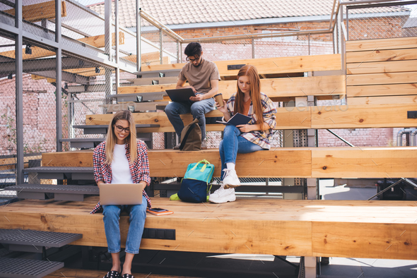 Three friends learning and preparing homework for school lessons Stock ...