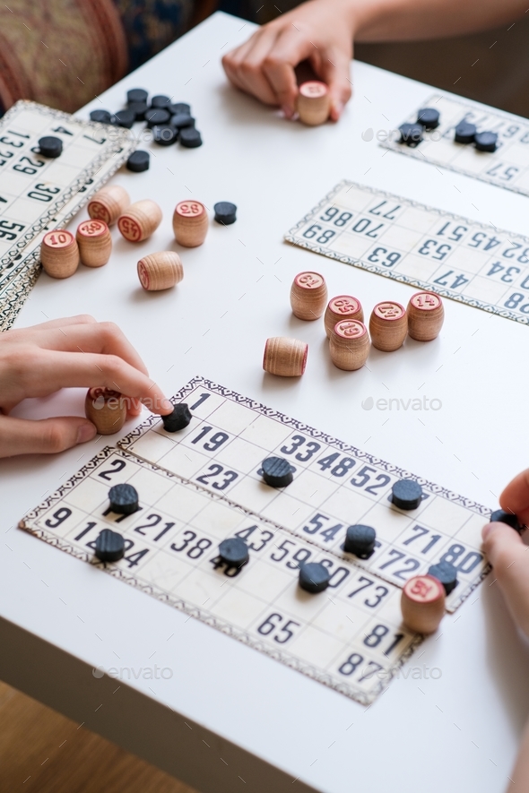 Two children are playing board games. Lotto Bingo Game set. Cozy home ...