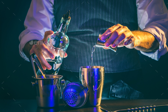 Bartender pouring vodka into cocktail shaker Stock Photo by ...