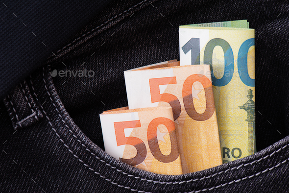 Folded Euro banknotes sharpen from the pocket of black jeans. Stock ...