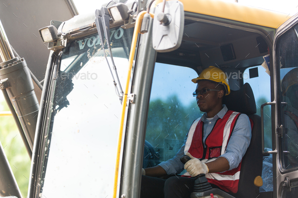 Construction worker person with backhoe loader or industry tractor ...