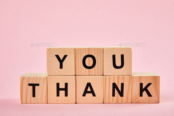 wooden blocks with thank you words on pink background with copy space ...