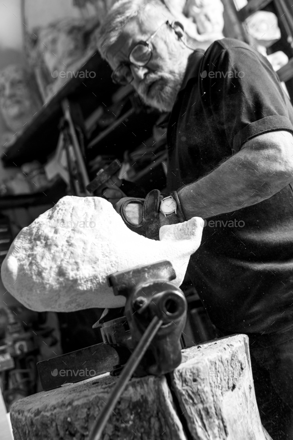 Senior sculptor working on his marble sculpture in his workshop with ...