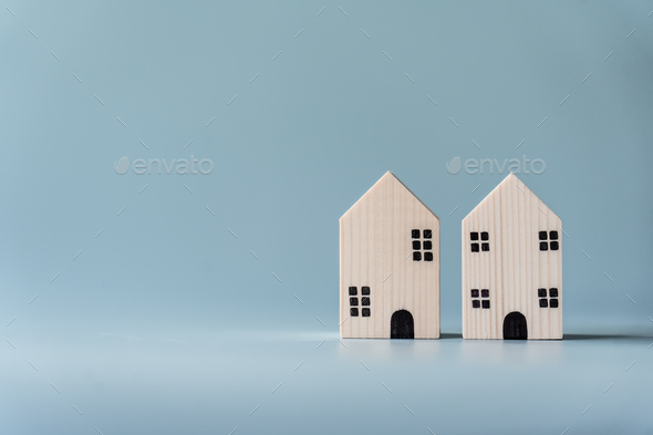 Small wooden house on light blue background for real estate and ...