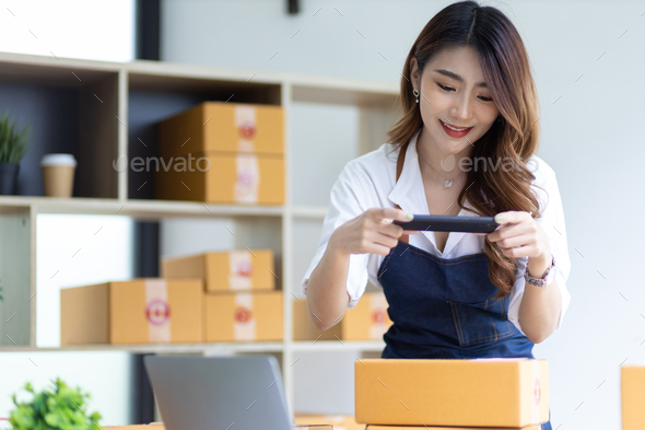 Female small business owner using mobile app on smartphone scanning ...