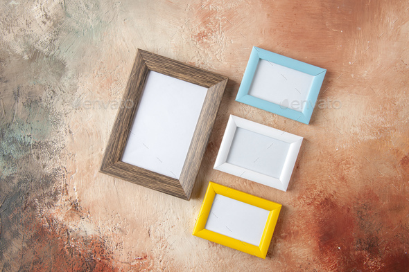 Above view of four wooden photo frames in different sizes hung on side ...
