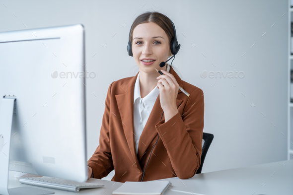 Customer service executive working at the office. Stock Photo by thichas