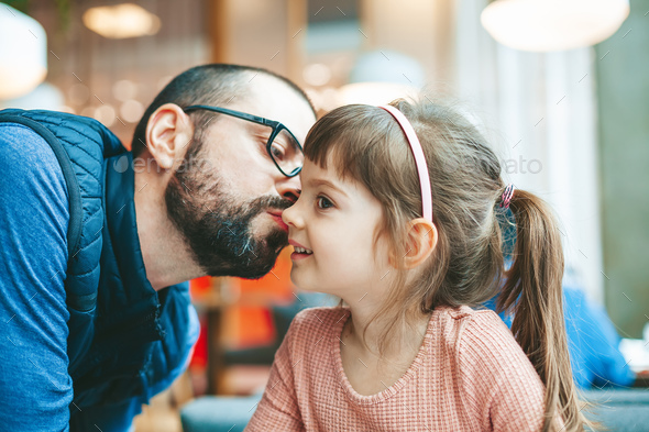 Father kissing his cute little daughter Stock Photo by anita_bonita