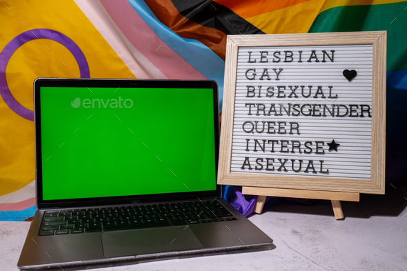 Laptop with chroma key on Rainbow LGBTQIA flag made from silk material ...