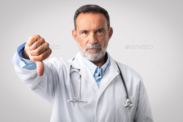 Serious confident european old man doctor in white coat with ...