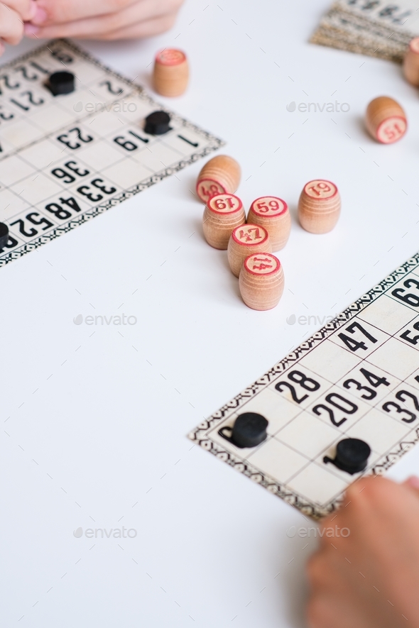 Two children are playing board games. Lotto Bingo Game set. Cozy home ...