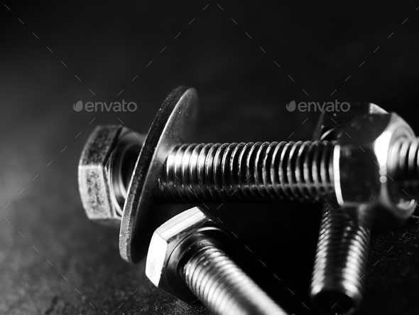 Closeup shot of metal screw threads isolated on the black background ...