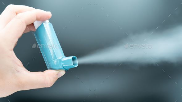 inhaler pushed down visible cloud of particles Stock Photo by wirestock