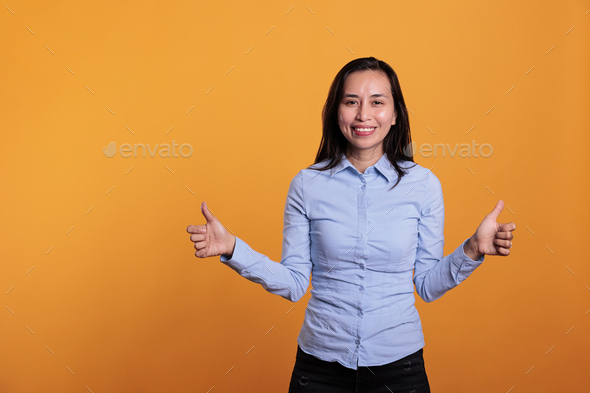 Filipino woman doing thumbs up gesture in front of camera Stock Photo ...