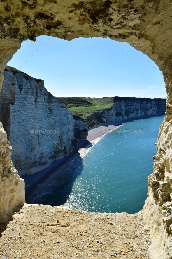 view through a hole at cliffs, a beach and the sea Stock Photo by ...