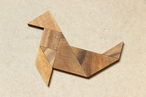 Wooden tangram in seal or sea lion shape on wood background Stock Photo ...