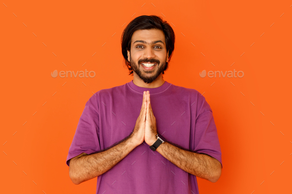 Happy positive handsome indian guy showing namaste gesture Stock Photo ...