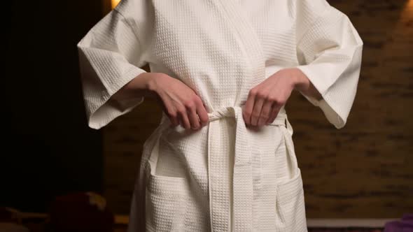 the woman unties the belt of the robe and does not fully open it, Stock ...