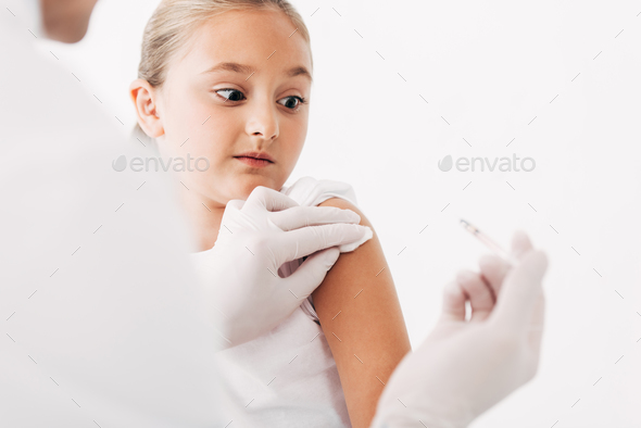partial view of pediatrist doing injection to child isolated on white ...