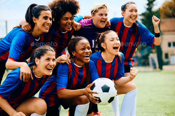 Multiracial team of female soccer players celebrating victory at the ...