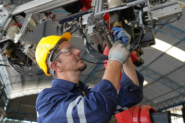 Robotic Arm engineer check on equipment in its with software of an ...