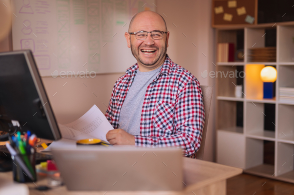 Man laughing while working in an office Stock Photo by Impactphotography