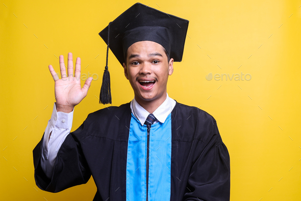 Young man in graduation cap and ceremony robe waving hand gesture to ...
